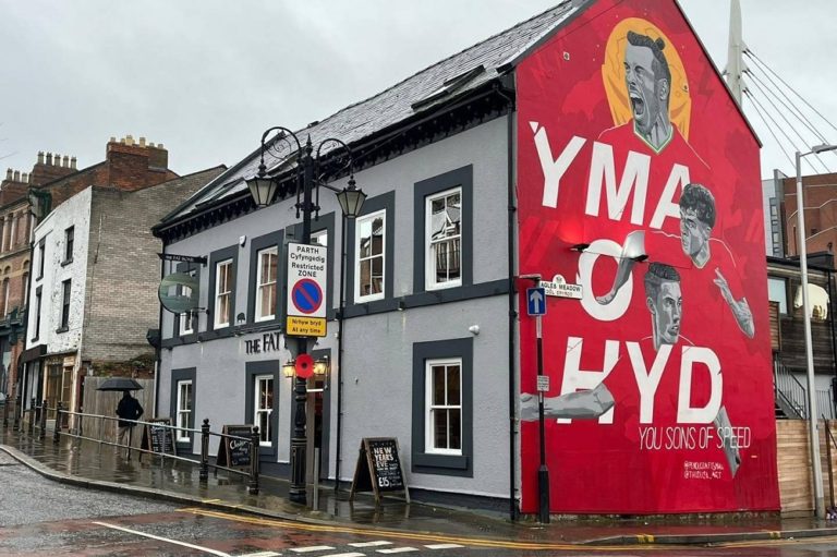 A giant mural of Paul Mullin has appeared in Wrexham